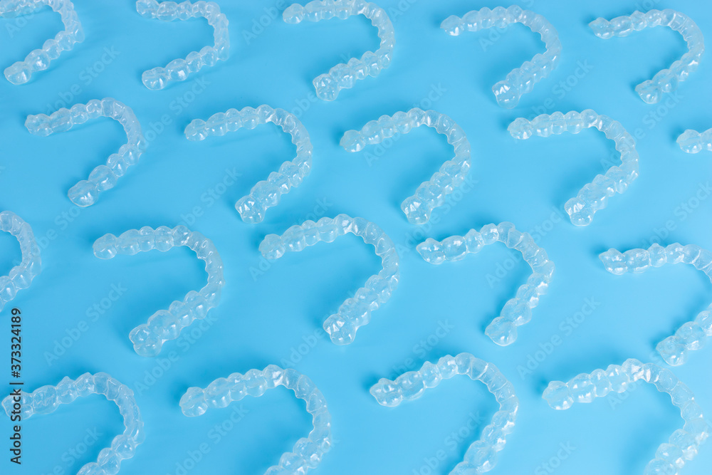 Invisalign transparent braces or brackets pattern on blue background ...