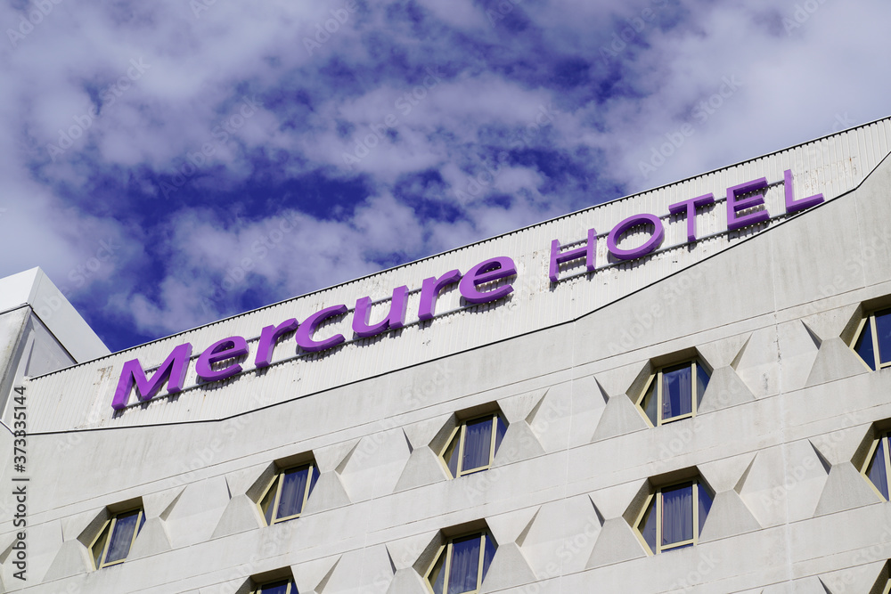 mercure hotel text and sign logo on building facade in blue cloudy sky ...