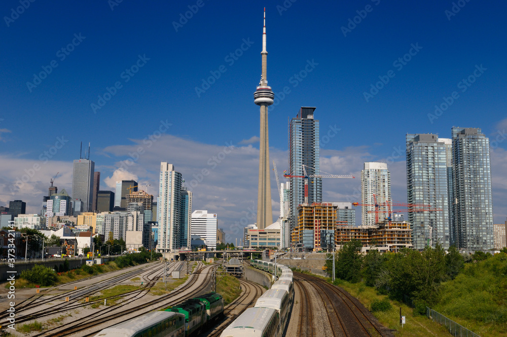 GO trains leaving on rail corridor from downtown Toronto highrise ...
