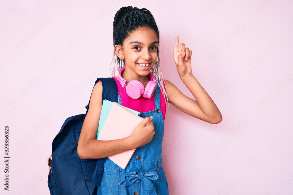 Young african american girl child with braids holding student backpack ...