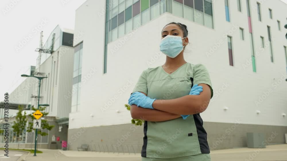 Indian woman, POC, nurse doctor wearing PPE uniform, mask, gloves ...