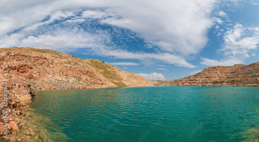 Emerald lake in a flooded quarry. Emerald green lake in flooded ...