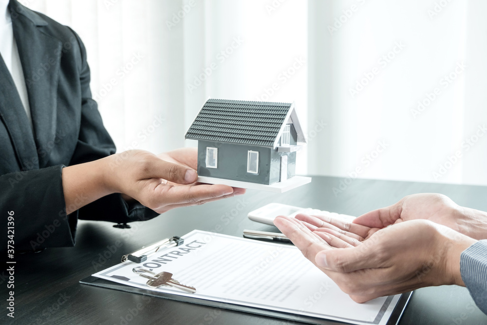 Real estate agent broker hand over the home to the new owner after ...