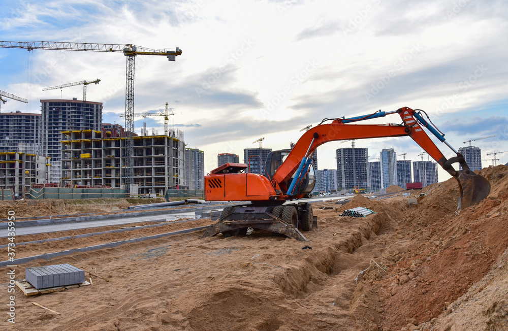 Excavator dig trench at a construction site. Trench for laying sewer ...