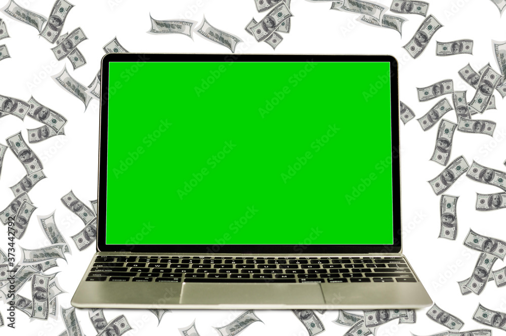 Modern laptop with mock up green screen among falling dollar money ...