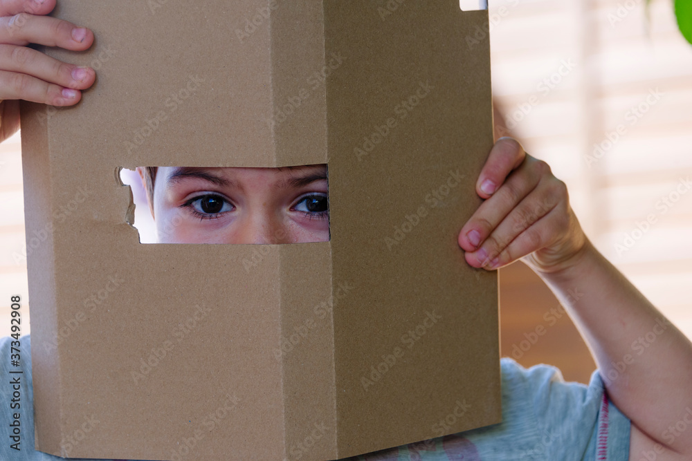 child hides in cardboard where only part of the face is visible Stock ...