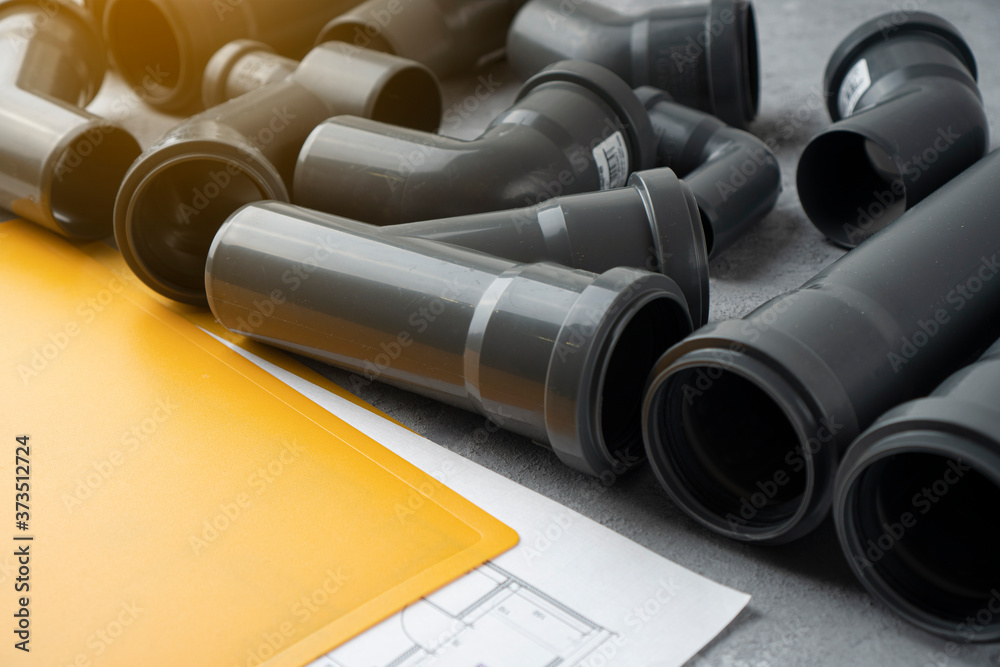 Plumbing pipes and house project on a concrete background. Stock Photo ...