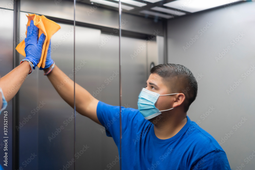 cleaning professional thoroughly disinfecting the elevator Stock Photo ...