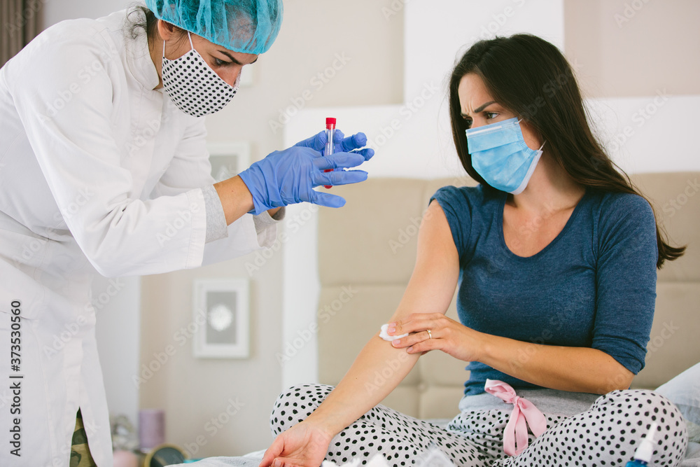 Nurse with mask protection drawing blood sample for Covid 19 test, from ...