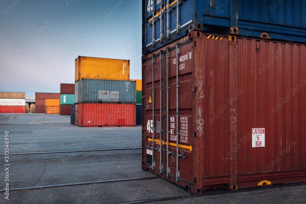 Stacked cargo containers in storage area of freight sea port terminal ...