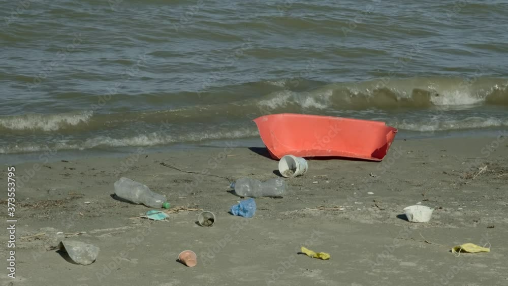 Plastic pollution on the sandy shore. Plastic and other garbage from ...