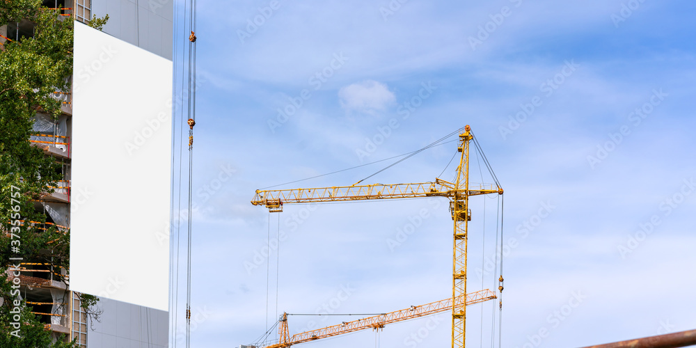 vertical big banner on side of building wall of construction site with ...