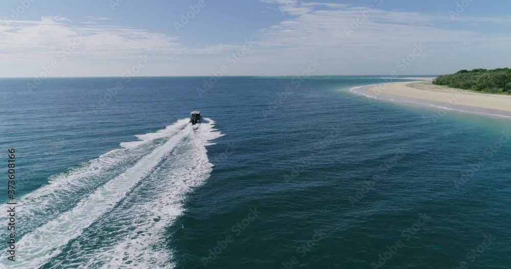 Summer maritime scene of small metal motor speed boat cruising alone ...