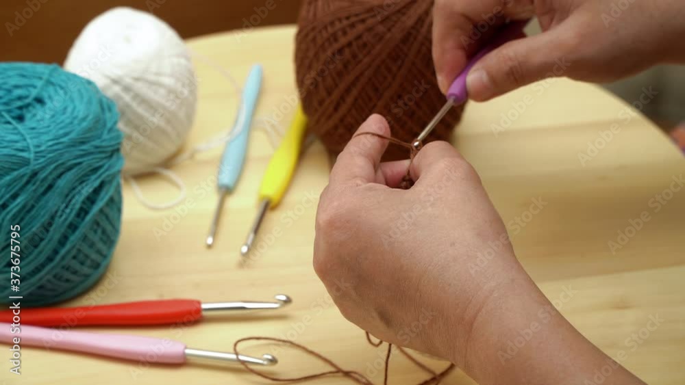 Crocheting Amigurumi technique, close up footage of woman's hands ...