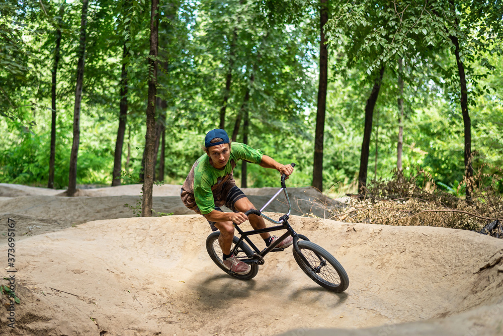 Poster A bmx cyclist makes a sharp turn on a forest trail – Wall Art ...