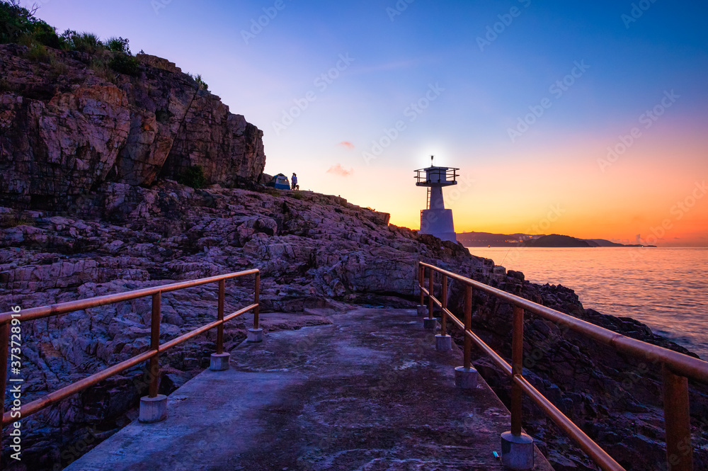 Mount Johnston Lighthouse at Ap Lei Pai beaming light ray in marine at ...
