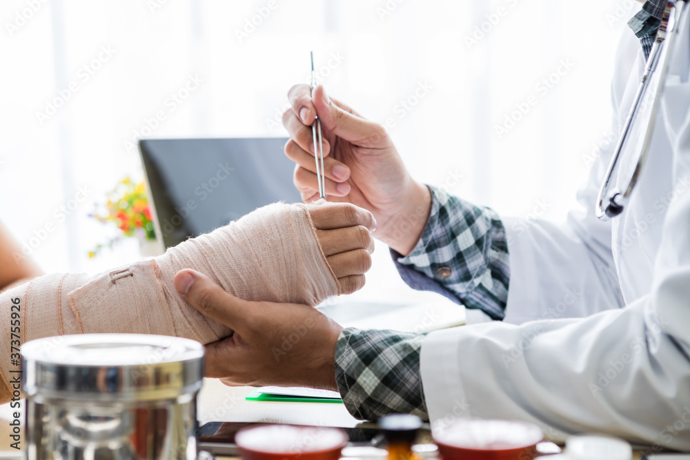 man doctor of checking splint the arm of female patient hand due to ...