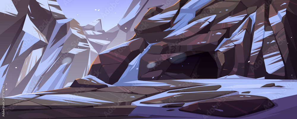 Entrance to cave in mountain with ice and snow on rocks around. Grotto ...