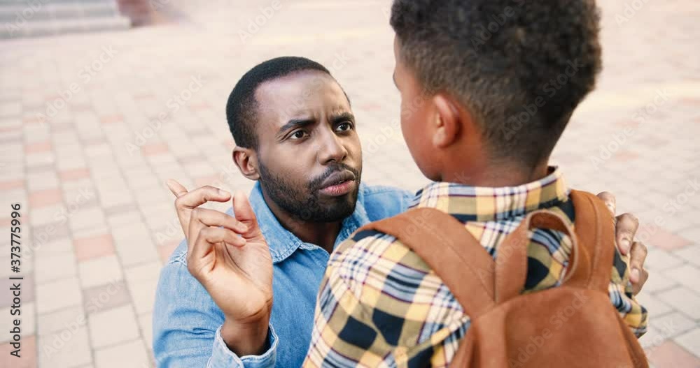 Close up portrait of serious unhappy African American man talking with ...