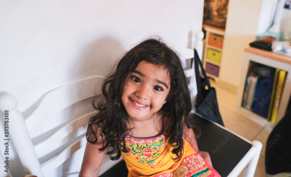 Indian child wearing sari dress - Southern asian child sitting on a ...