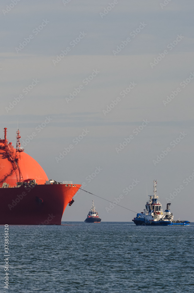 LNG TANKER - The red ship goes to the seaport Stock Photo | Adobe Stock