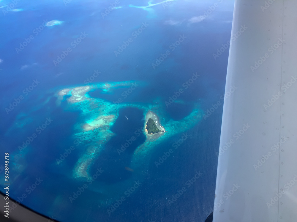 Tiny island and reefs from small plane Stock Photo | Adobe Stock