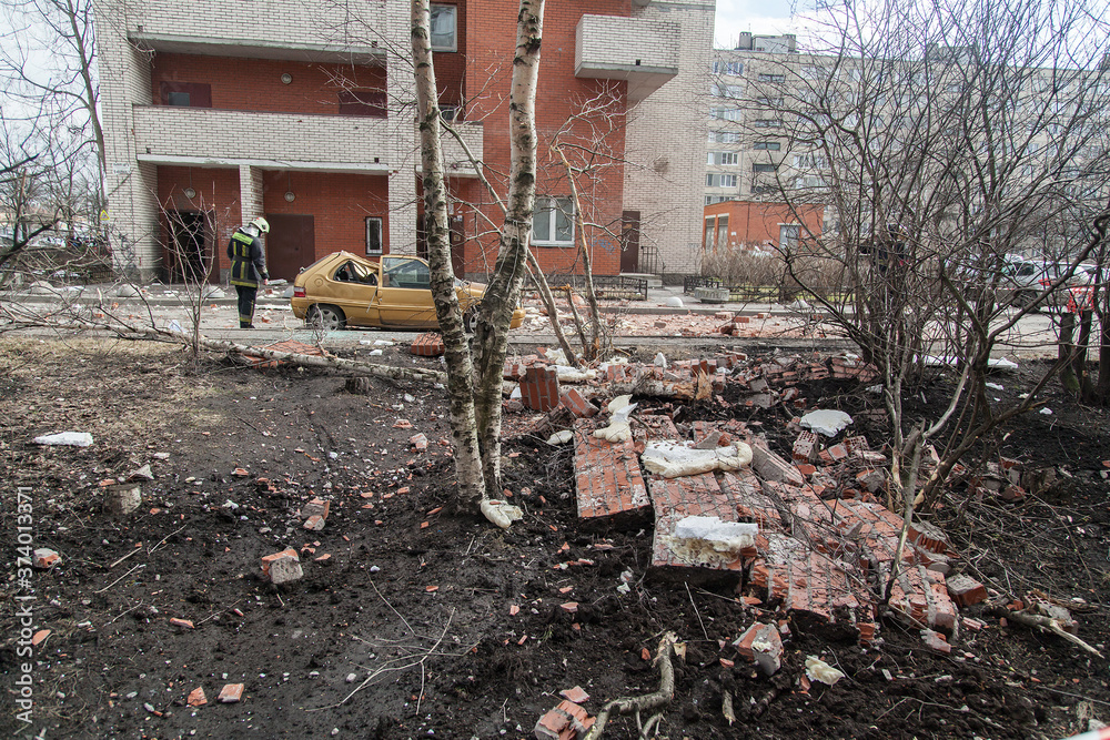 Russian rescuers at the site of the collapse of the wall of a brick ...