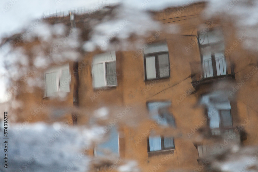 Vintage house windows reflected in a muddy puddle Stock Photo | Adobe Stock
