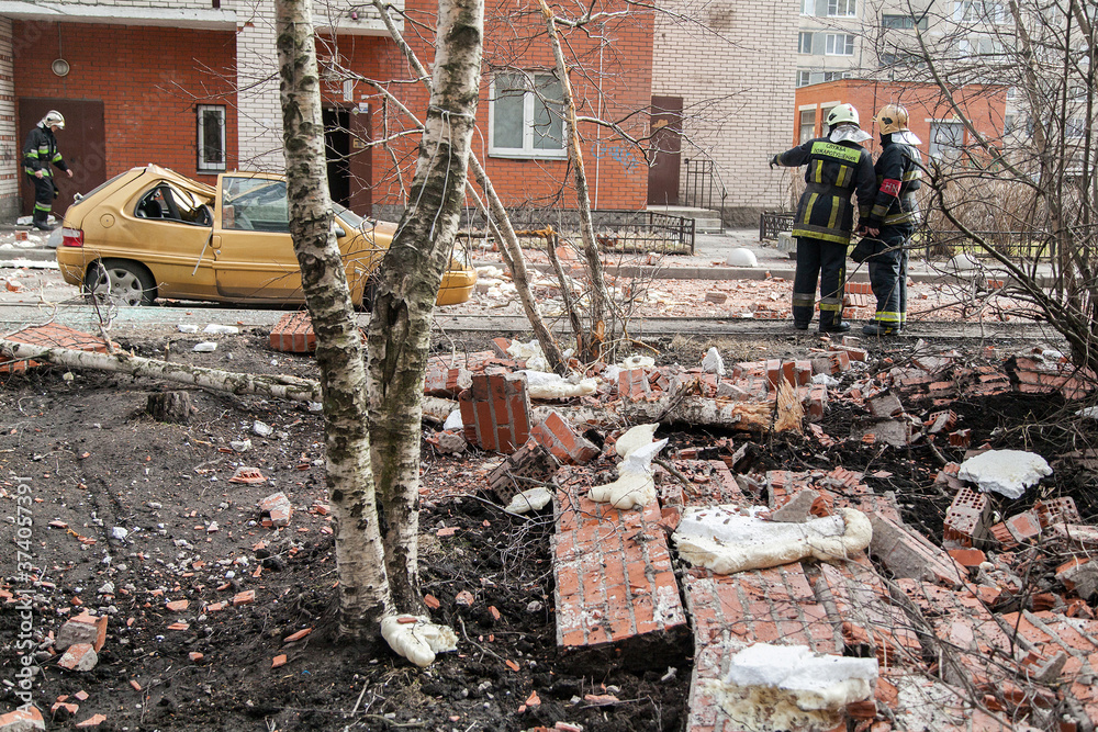 Russian rescuers at the site of the collapse of the wall of a brick ...