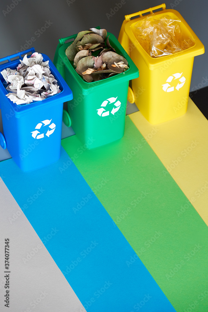 Three color coded recycle bins, isometric picture on geometric paper ...