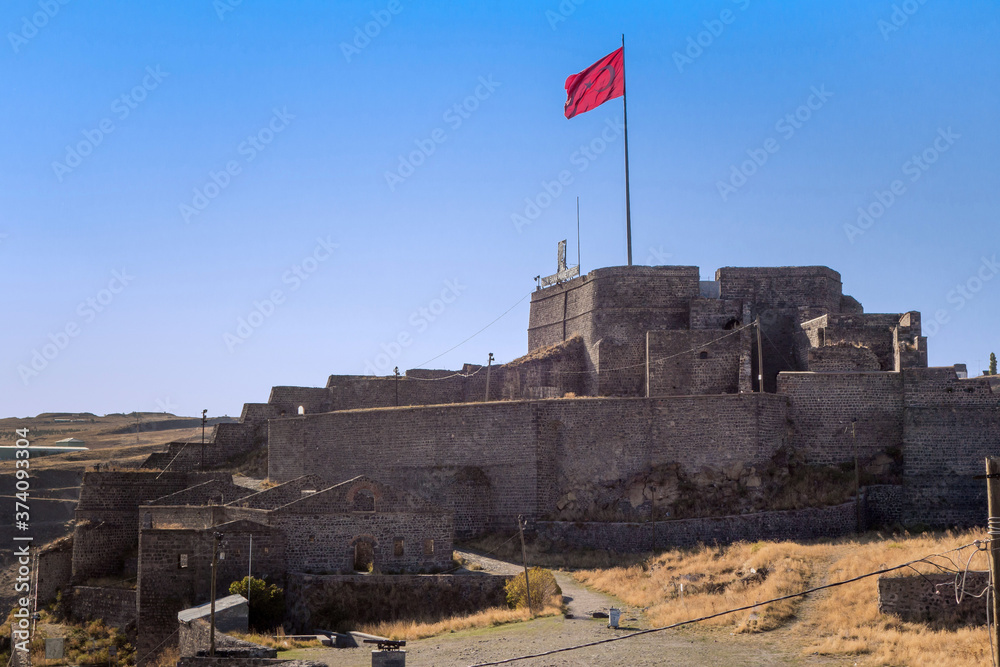 Citadel of Kars Castle, Turkish flag waving above it, remains of ...