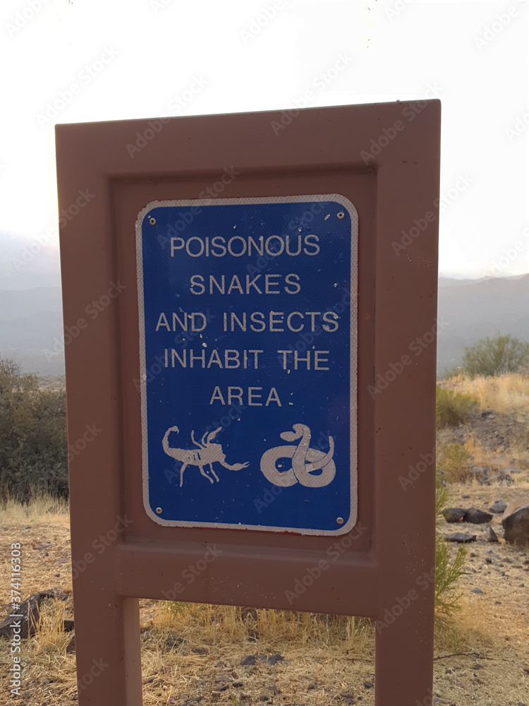 Warning sign of poisonous snakes and insects at a desert rest stop ...