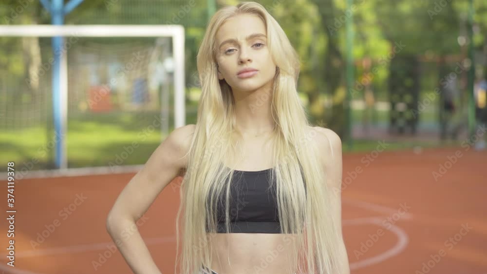 Camera moves up along gorgeous slim body of young confident cheerleader ...