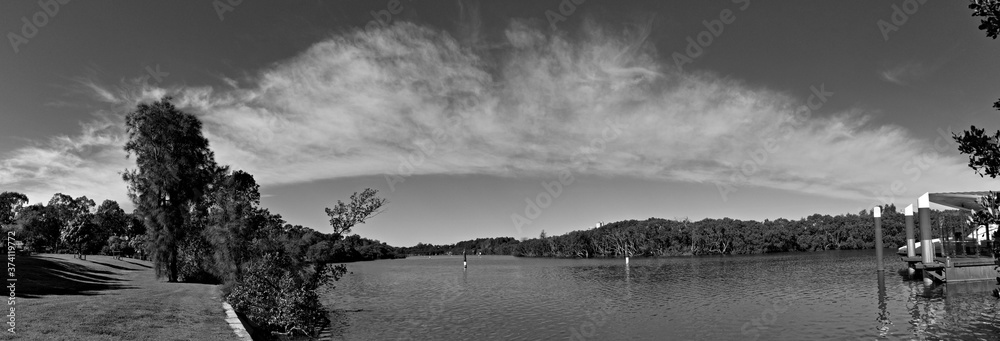 Beautiful black and white panoramic view of a river with rainbow look ...