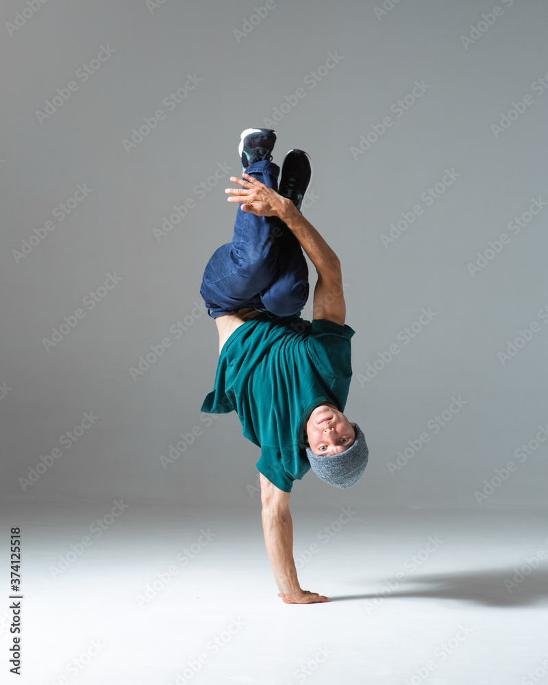 Cool guy breakdancer stands on one hand dancing lower break dance ...