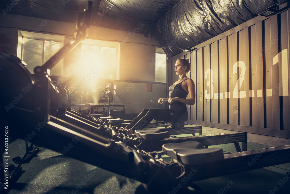 Flexible, strong. Young caucasian female athlete training in gym, doing ...