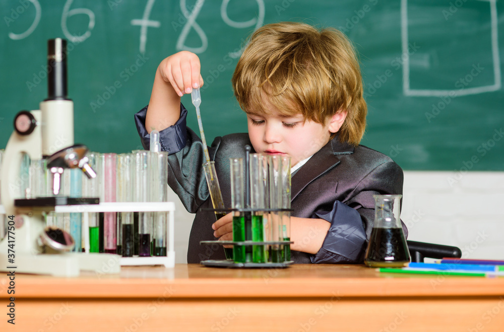microscope at lab. small boy using microscope at lesson. student do ...