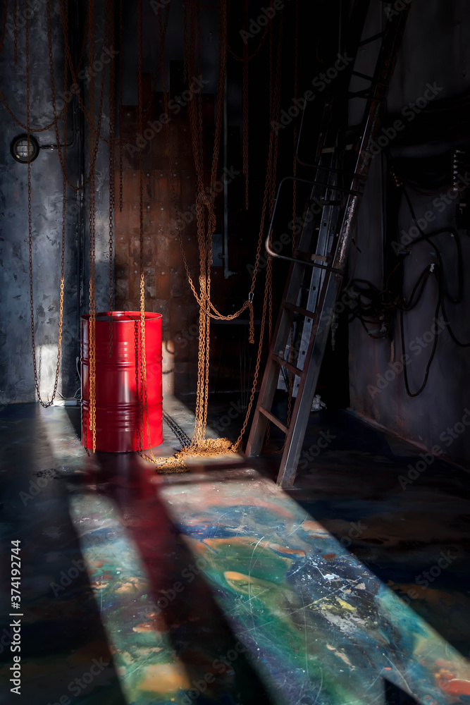 Interior of factory industrial shop with chains and a red barrel is ...