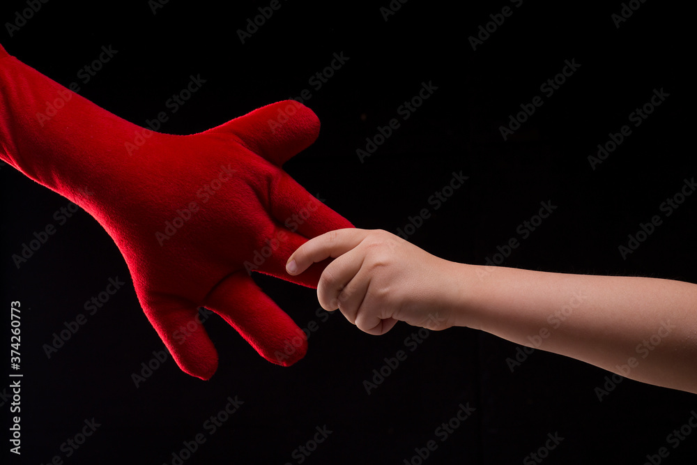 Cute little boy hand holding big red soft toy hand. Young boy and his ...