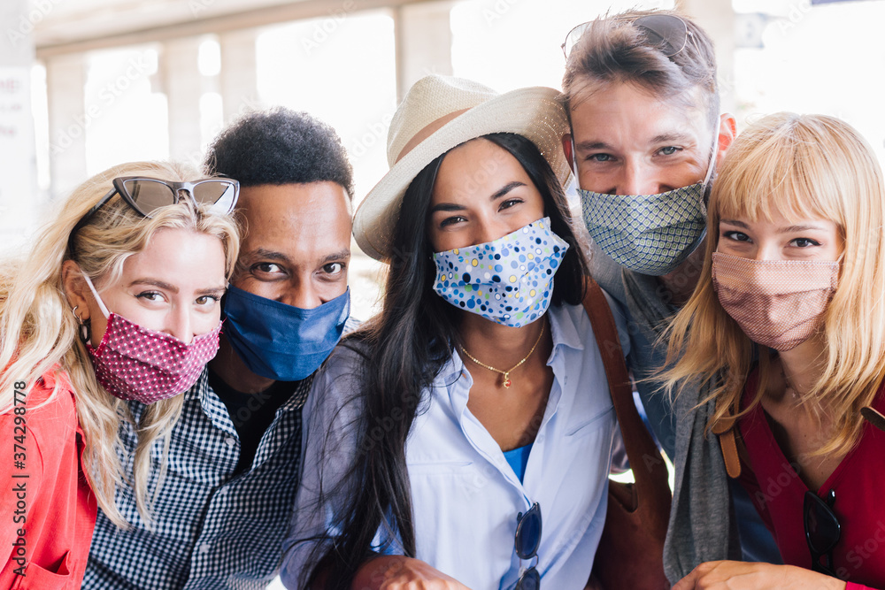 Portrait group of young happy friends wearing face mask during Covid ...