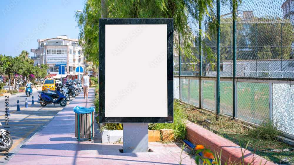 vertical street banner in black frame for mockup stands on sidewalk ...