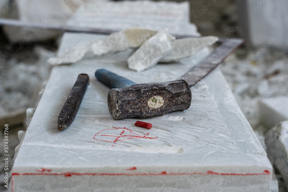 Sculptor tools on a marble slab, close up. Workplace, traditional tools ...