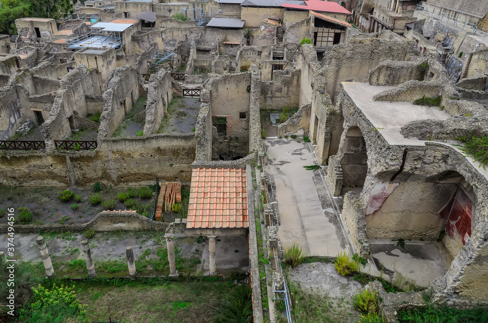 Located in the shadow of Mount Vesuvius, Herculaneum (Italian: Ercolano ...