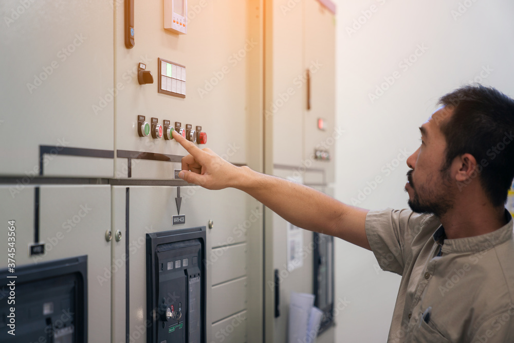 Electrical engineer man checking voltage and test at the Power ...