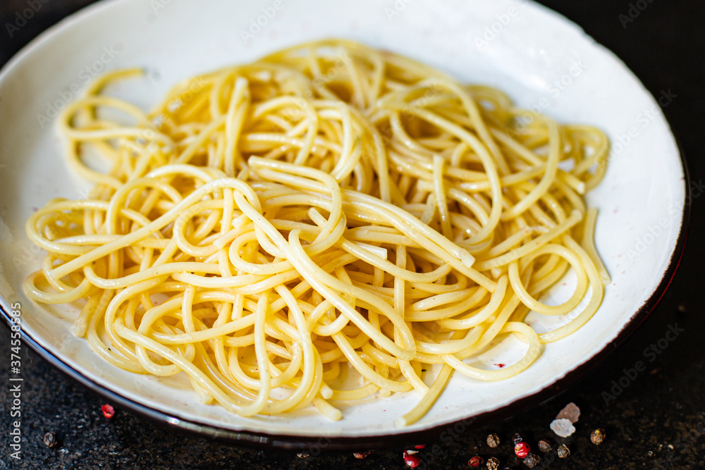 spaghetti pasta on a plate macaroni from semola durum wheat on the ...
