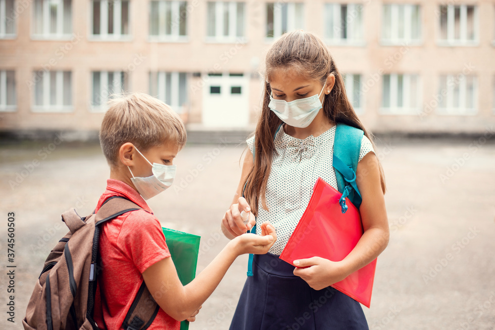 Caucasian children going to school. Small girl and boy in protective ...
