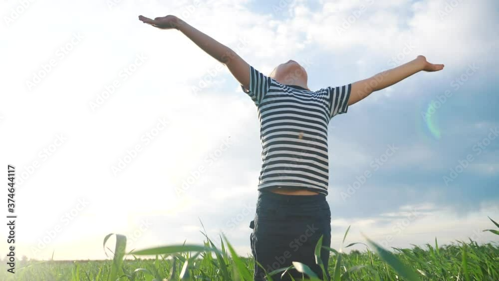 boy prays pulls hands to the sky against a blue sky. child concept ...
