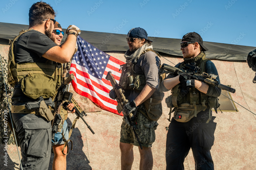 Professional shooters speaking cheerfully while giving advice to young ...