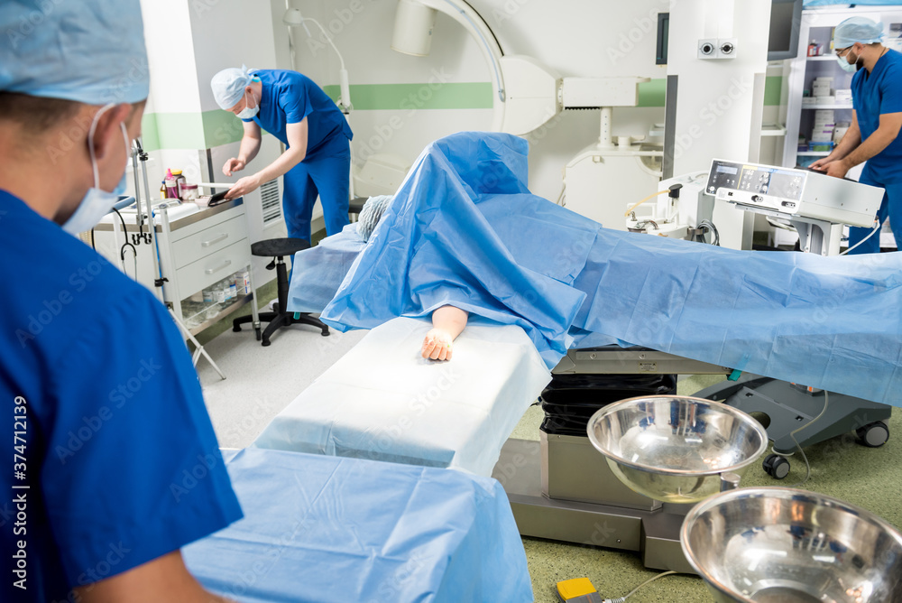 Surgeons in the operating room trying to save the patient's hand. Stock ...