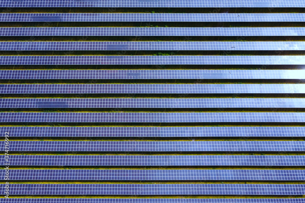 Drone aerial view of a photovoltaic solar system. Metallic blue solar ...